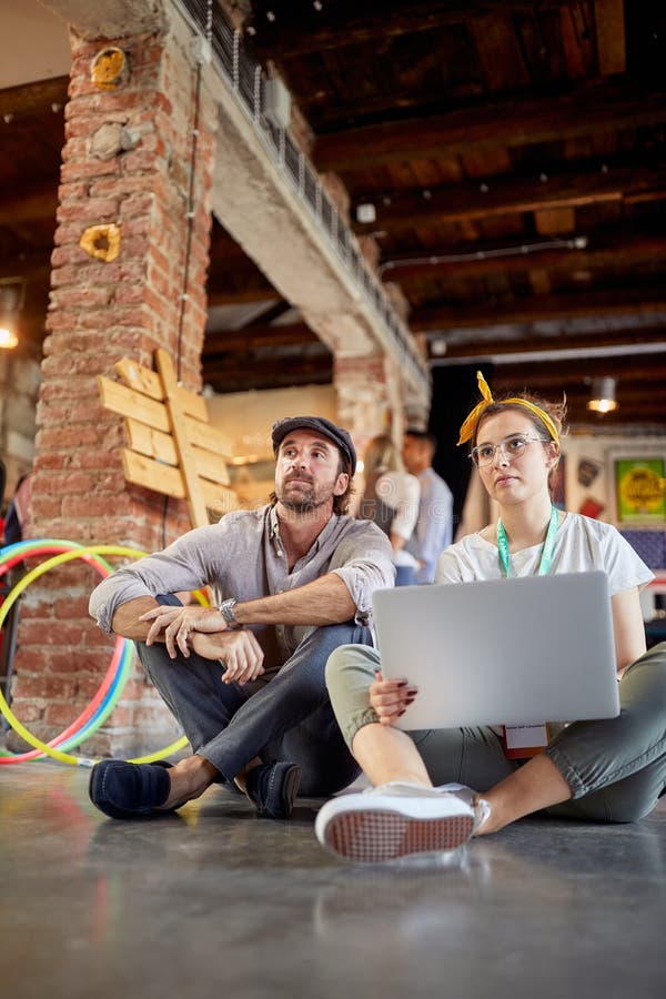 Young Creative Colleagues in a Thoughtful Phase while Sitting on the ...