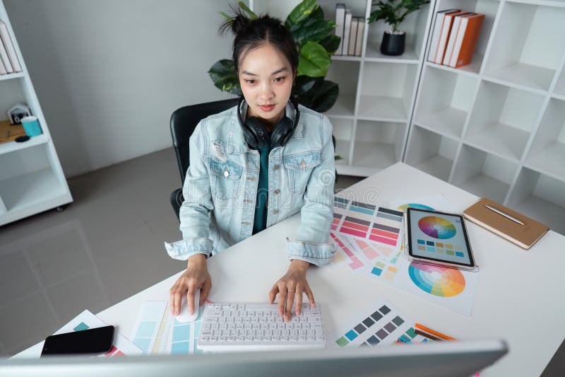 Young Creative Designer Working on Computer with Color Swatches and ...