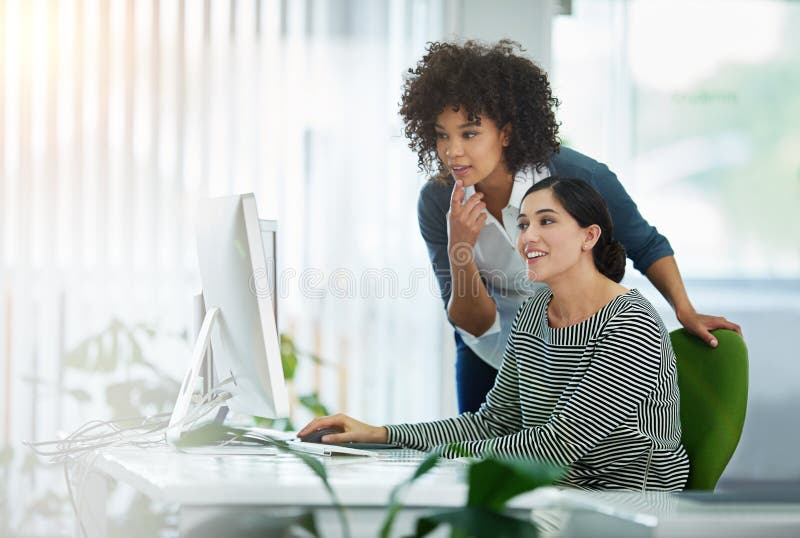 Young Creative Designers Working Together on a Computer at a Desk in a ...