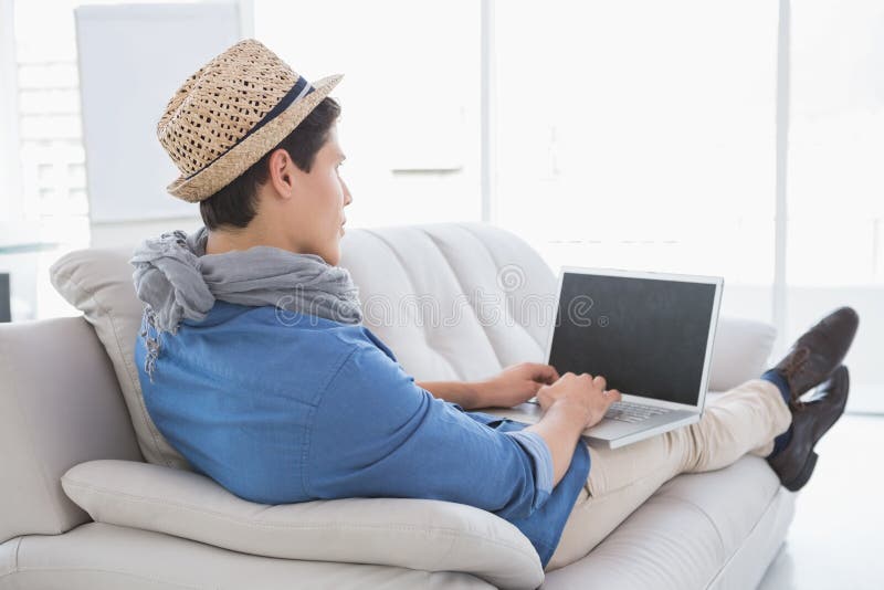 Young Creative Man Using Laptop on Couch Stock Image - Image of ...