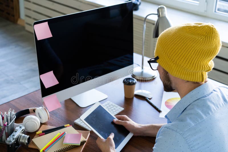 Young Creative Manager Sitting at His Table and Working on Computer ...