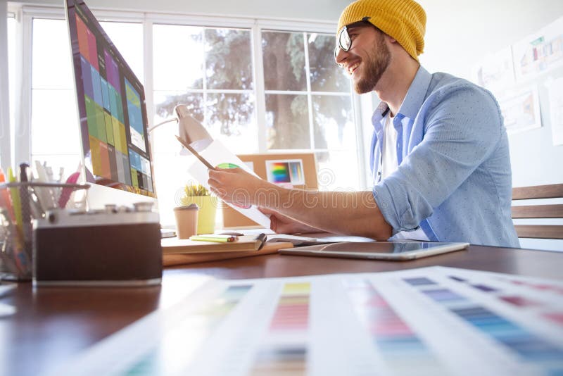 Young Creative Manager Sitting at His Table and Working on Computer ...