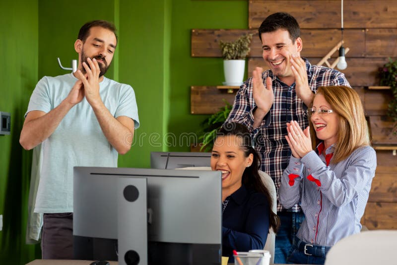 Young Creative Team in Start-up Company Clapping in Front of PC Screen ...