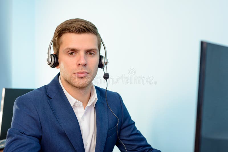 Young Customer Support Phone Operator with Headset at His Working Place ...