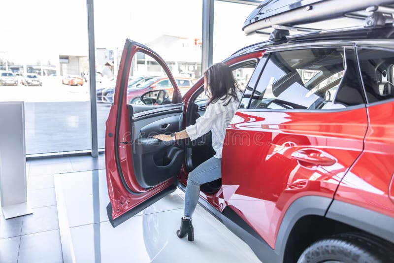 A Young Customer Takes Advantage of the Inspection of a New Car in the ...