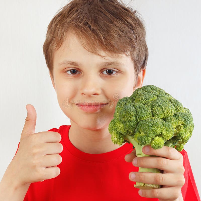 Young Cut Boy in a Red Shirt Recommends Broccoli on White Background ...