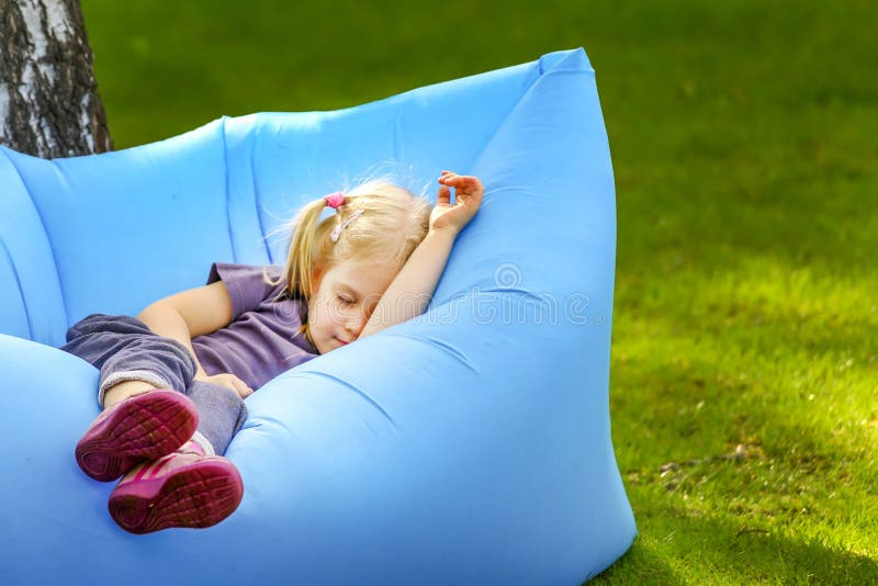 Young Cute Blond Girl Sleeping on an Inflatable Bed Outdoors Stock ...