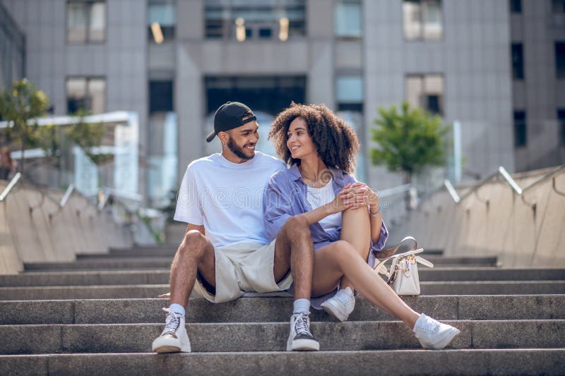 Young Cute Couple Sitting on the Steps and Looking Peaceful and Happy ...