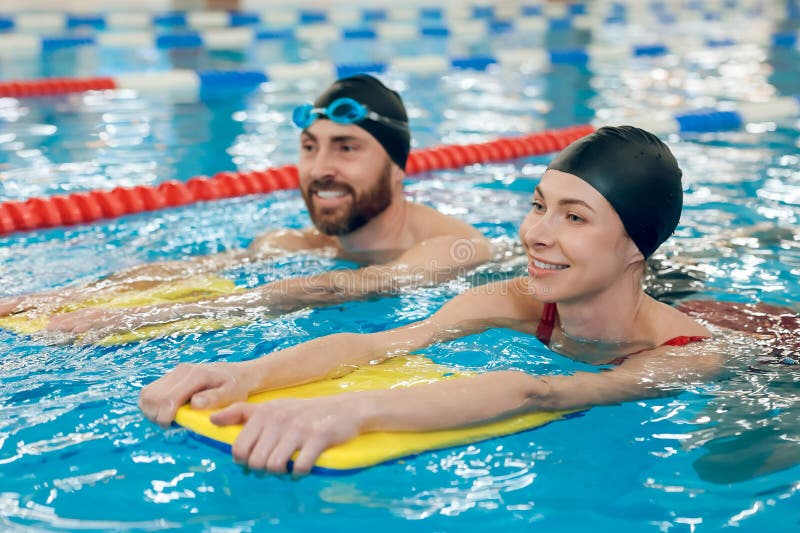 Young Cute Couple in Swimming with Boards in the Pool Stock Image ...