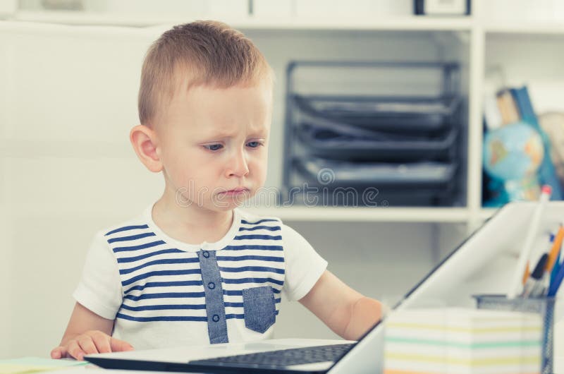 Young Cute Boy is Playing on Laptop Stock Photo - Image of playing ...