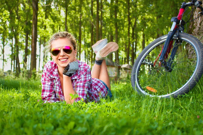 Young Cyclist Relaxation Lying in the Grass Stock Photo - Image of ...
