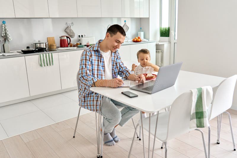 Young Dad Sitting in Kitchen at Home with Kid Watch Education Classes ...
