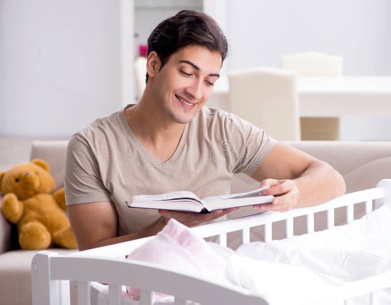 Young Dad Student Preparing for Exams and Looking after Baby Stock ...
