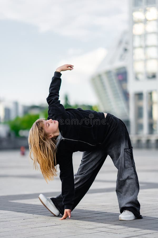 Young Dancer Performing Dynamic Move Outdoors in Modern Urban Setting ...