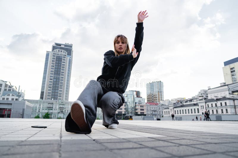 Young Dancer Performing a Dynamic Move in an Urban Setting during the ...