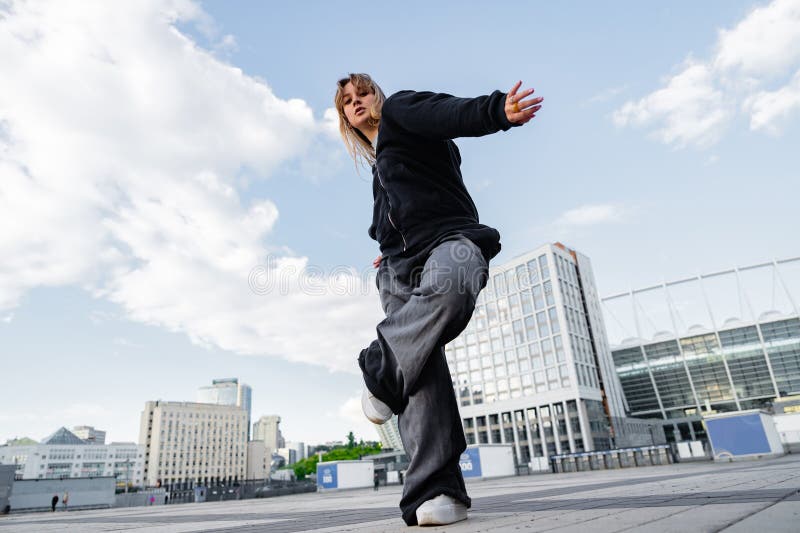 Young Dancer Performing Dynamic Moves in Urban Setting Under Clear Sky ...
