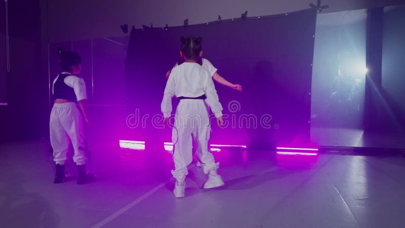 Young Dancers Performing in Studio with Purple Lighting Stock Footage ...