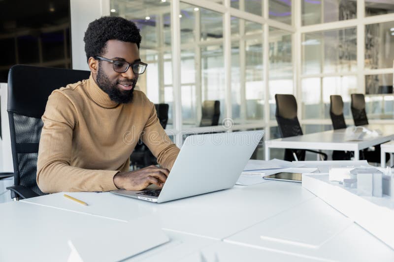 Young Dark-skinned Man Working on the Laptop in the Office Stock Image ...