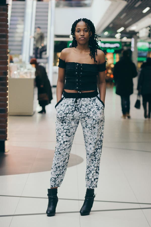 Young Dark Skinned Woman Dressed In Casual Clothes On The Bench In The