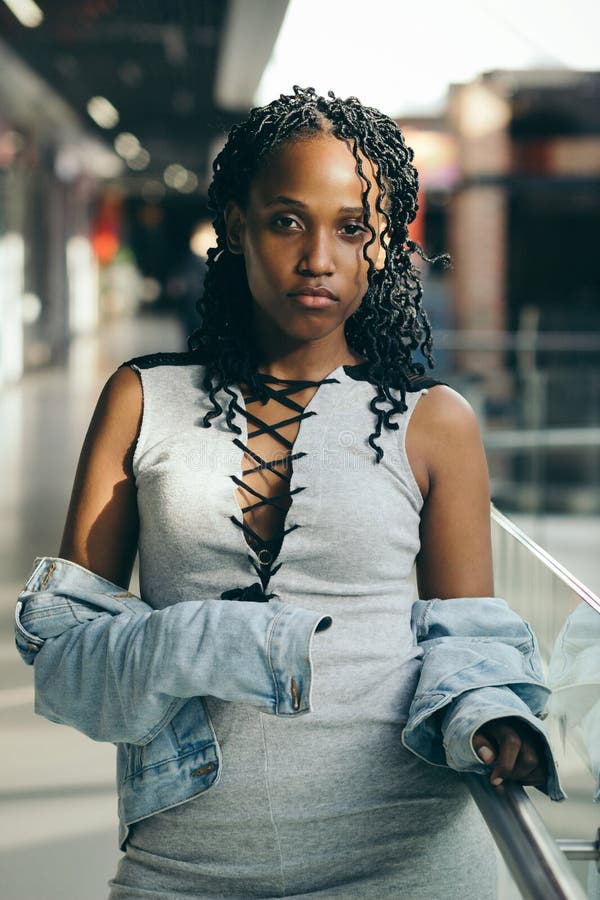 Young Dark Skinned Woman Dressed In Casual Clothes On The Bench In The