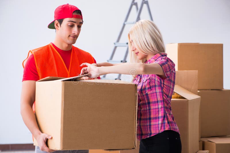 Young Delivery Assistant Delivering To Home Stock Photo - Image of move ...