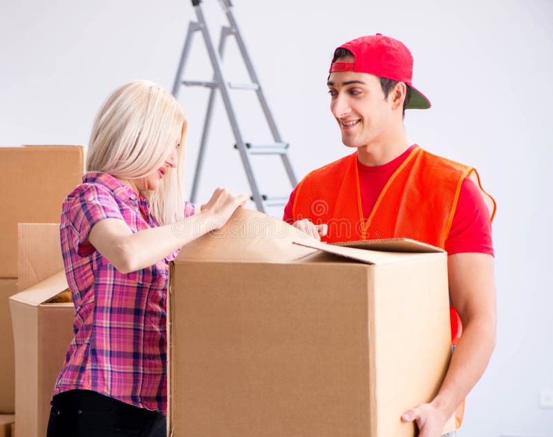 Young Delivery Assistant Delivering To Home Stock Photo - Image of move ...