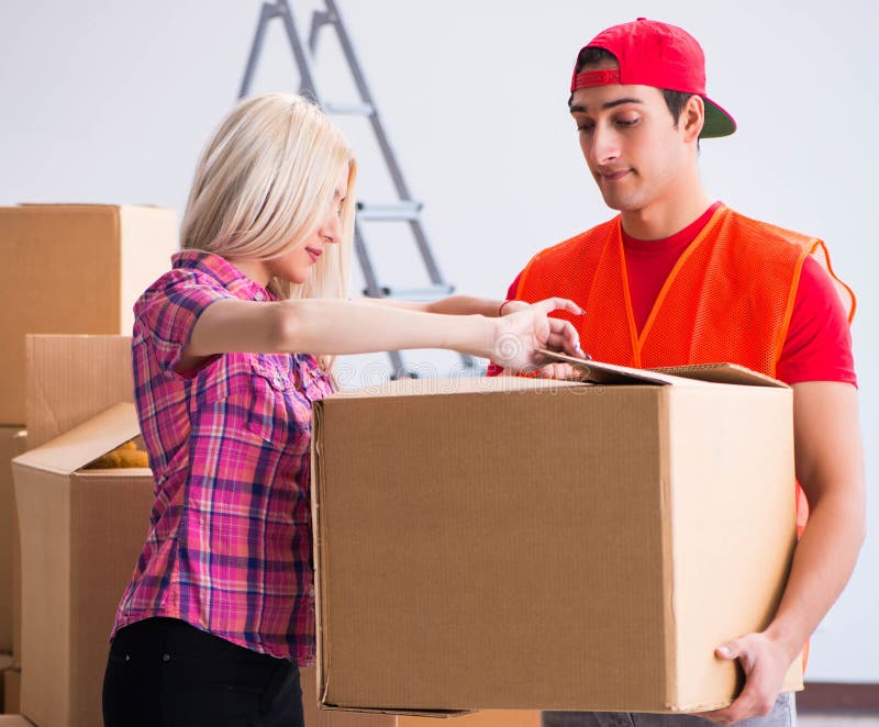 Young Delivery Assistant Delivering To Home Stock Photo - Image of move ...