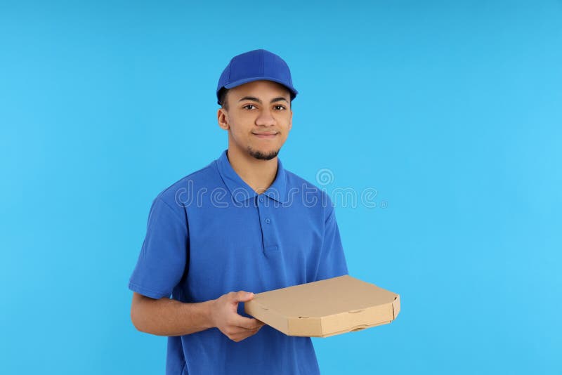 Young Delivery Man in Cap on Blue Background Stock Image - Image of ...