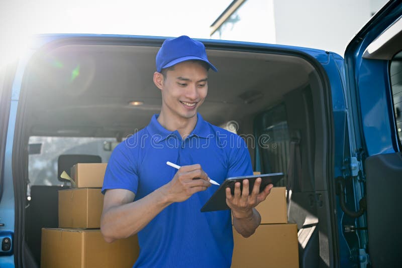 Young Delivery Man Checking Orders with Tablet before Handing Package ...