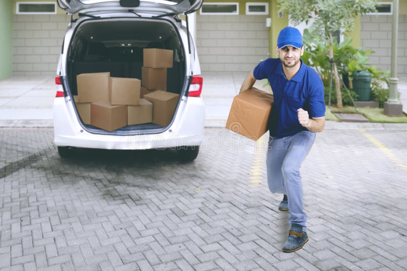 Young Delivery Man in Front Van with Cardboard Boxes Stock Photo ...