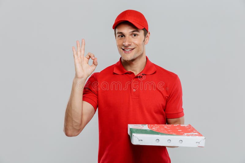 Young Delivery Man in Hat Gesturing while Posing with Pizza Box Stock ...