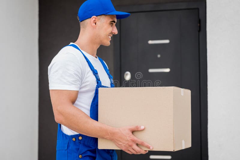 Young Delivery Man Hold a Cardboard Box in His Hands Stock Image ...