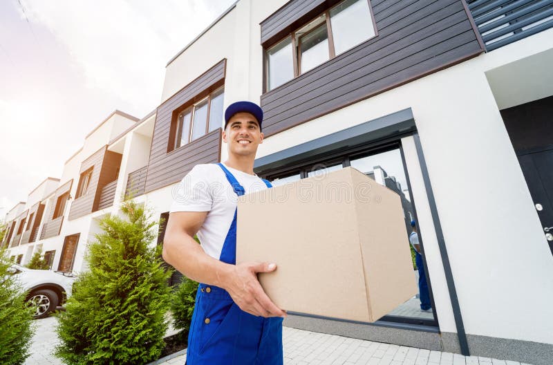 Young Delivery Man Hold a Cardboard Box in His Hands Stock Image ...