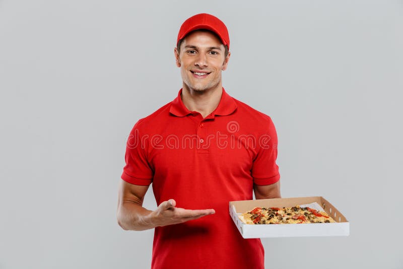 Young Delivery Man in Uniform Smiling while Showing Pizza Stock Image ...