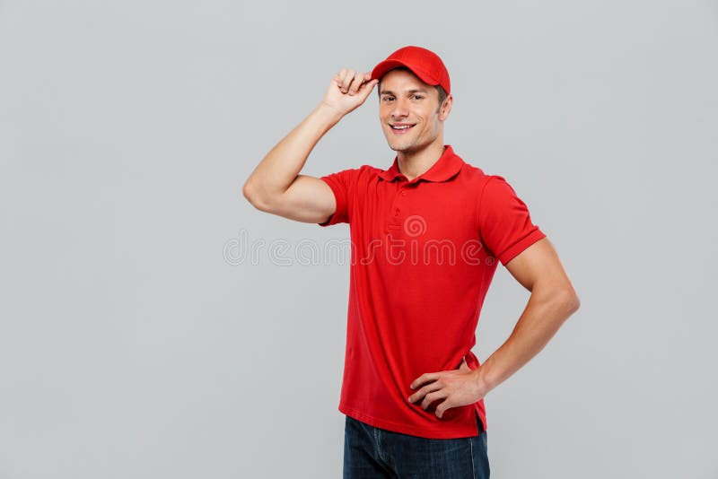 Young Delivery Man Wearing Red Hat Smiling and Looking at Camera Stock ...