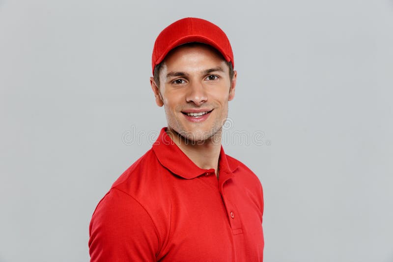 Young Delivery Man Wearing Uniform Smiling and Looking at Camera Stock ...