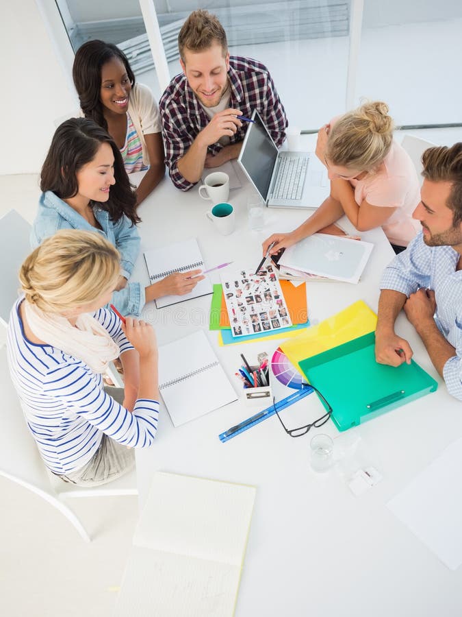 Young Design Team Going Over Contact Sheets Together Stock Photo ...