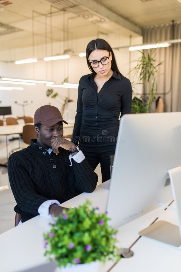 Young Design Team Working at Desk Looking at Computer in Creative ...