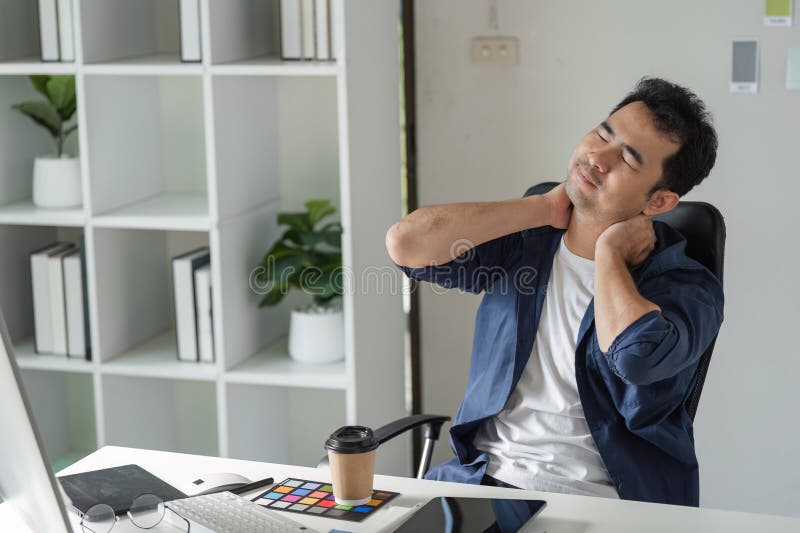 Young Designer Experiencing Neck Pain while Working at Desk in Modern ...