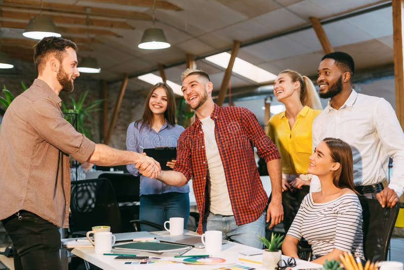 Young Designers Making Deal with Client and Shaking Hands Stock Image ...