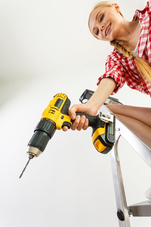Woman Using Drill on Ladder Stock Photo - Image of drill, equipment ...