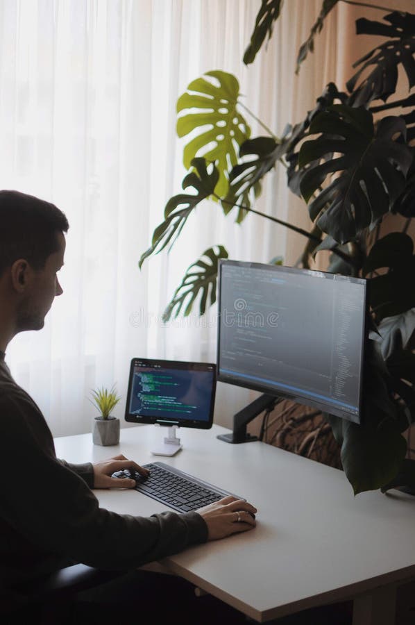 Young Developer Work with Curved Screen and Tablet.Freelancer is ...