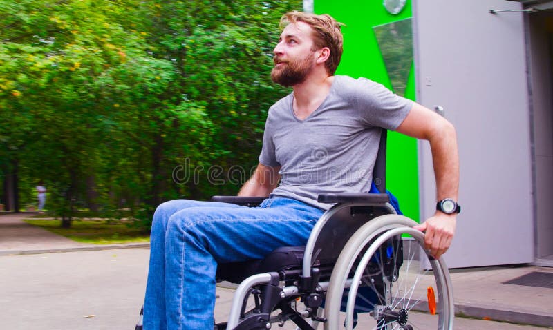 Young Disable Man Walking in the Park in Wheelchair Stock Photo - Image ...