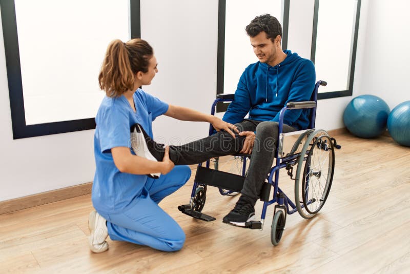 Young Disabled Man Making Mobility Exercise Sitting on Wheelchair at ...