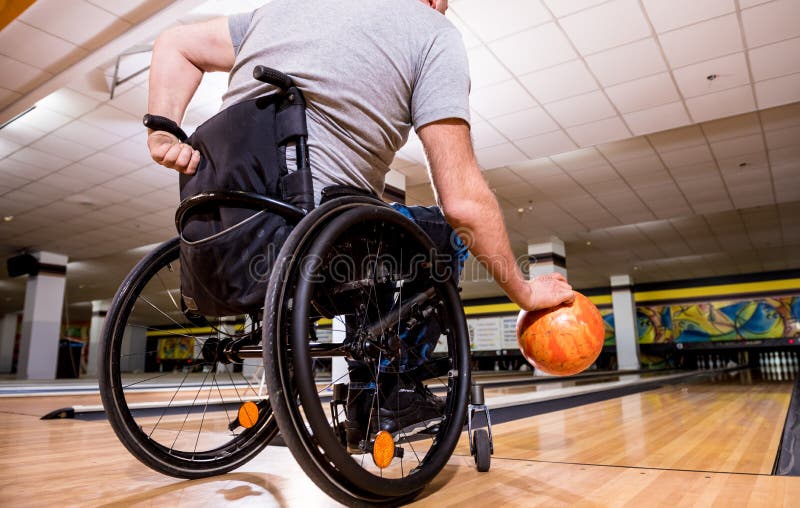 Young Disabled Man in Wheelchair Playing Bowling in the Club Stock ...