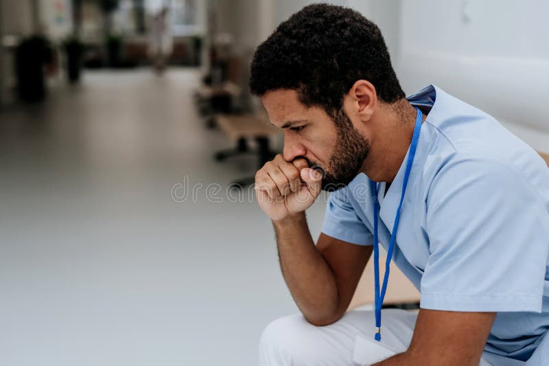 Young Distressed Doctor Sitting at Hospital Corridor Floor. Stock Image ...