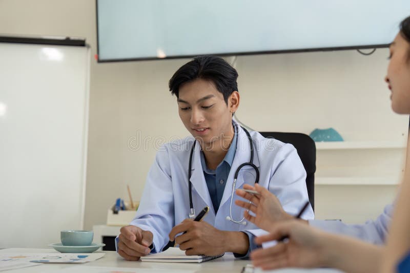 Young Diverse Doctor Taking Notes and Analyzing Data during a Team ...