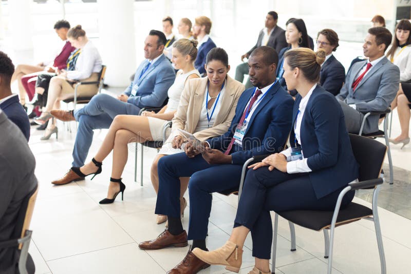 Young Diverse Executives Sat in Conference Room, Speaking Stock Photo ...