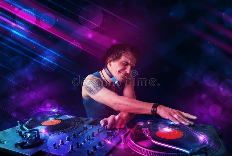 Young DJ Playing on Turntables with Color Light Effects Stock Photo ...