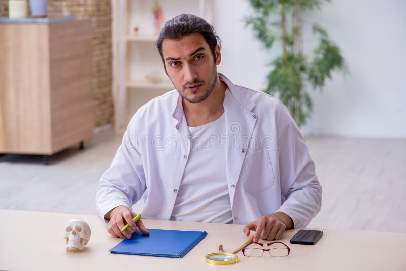 Young Male Doctor Demonstrating Human Skeleton Stock Image - Image of ...